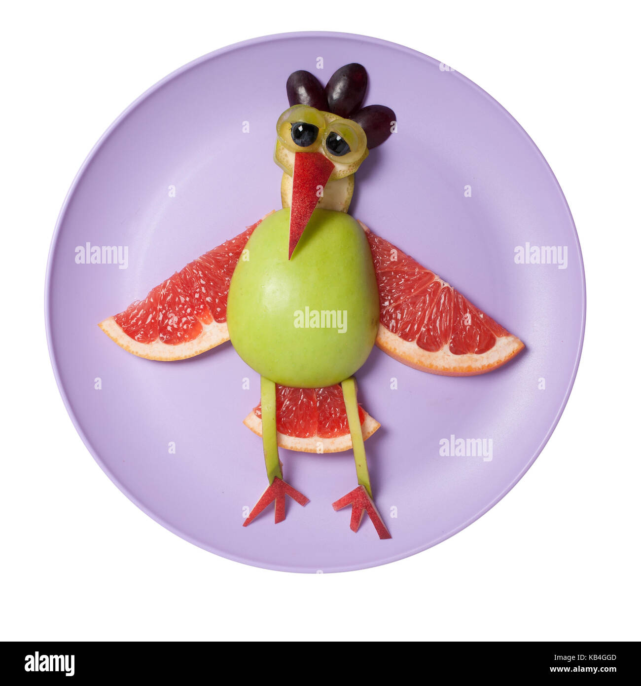Rooster made with fruits on purple plate Stock Photo - Alamy