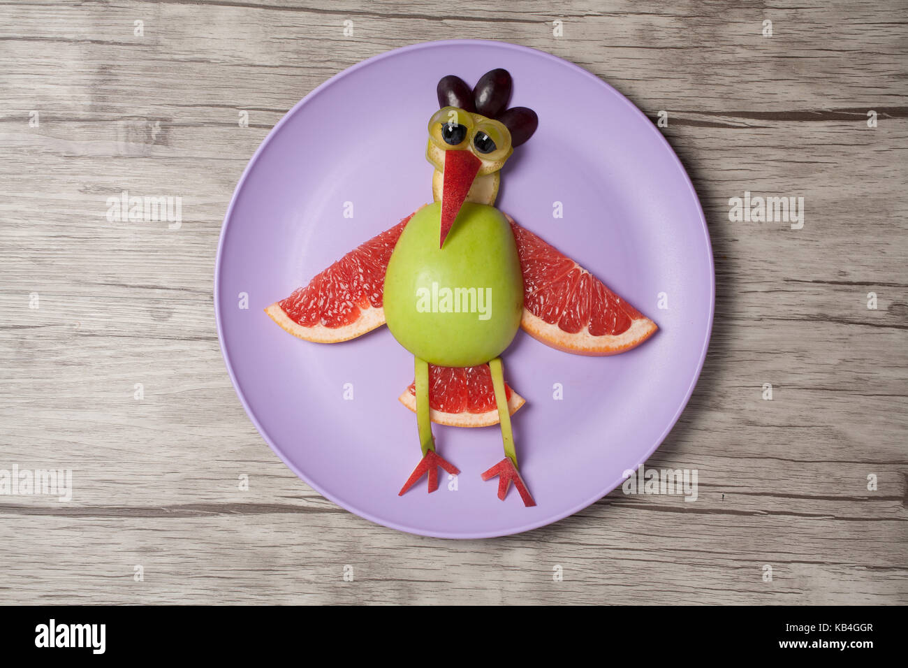 Rooster made with fruits on plate and table Stock Photo - Alamy