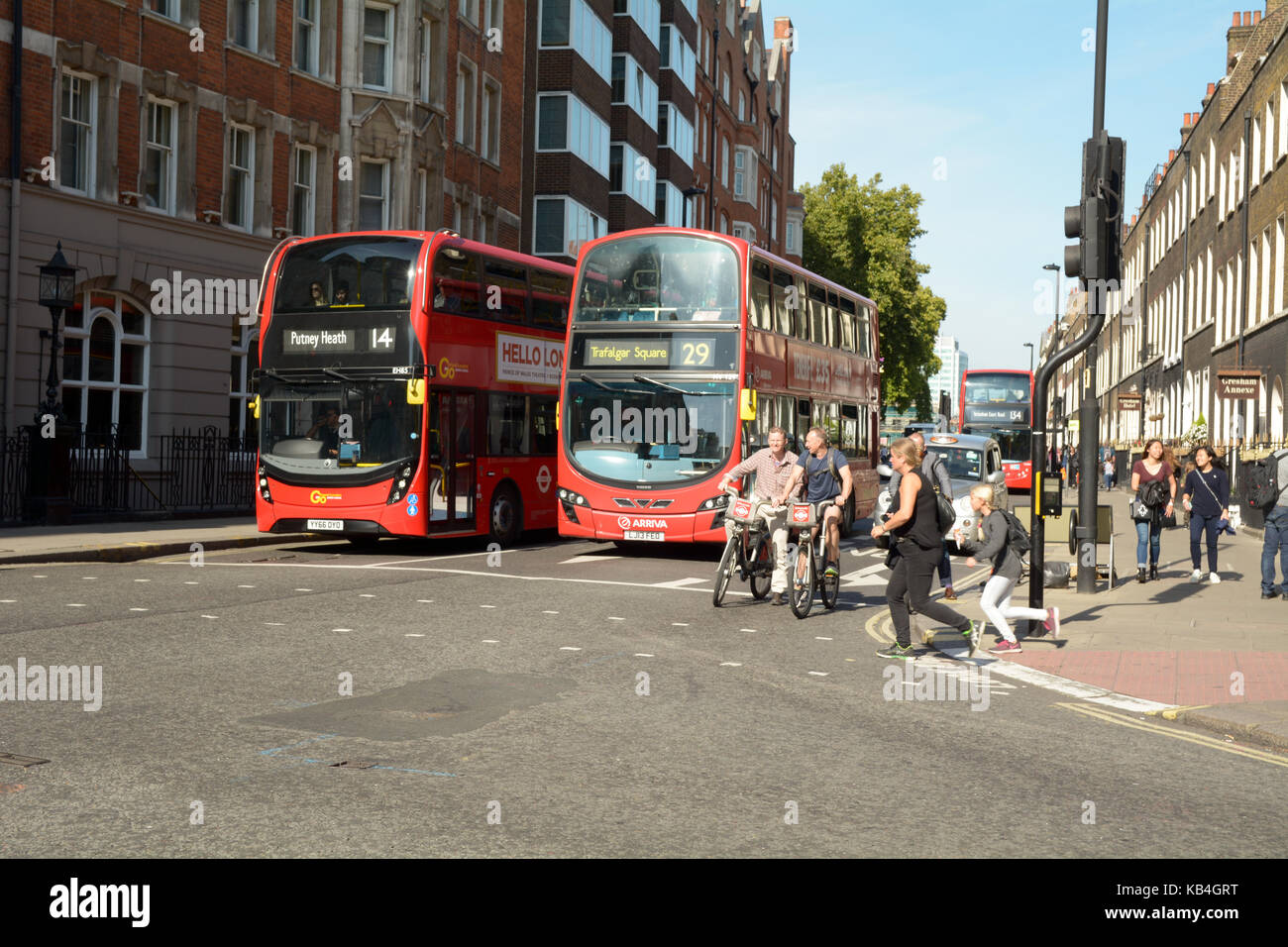 People riding Transport for London bikes at a road junction besides two ...