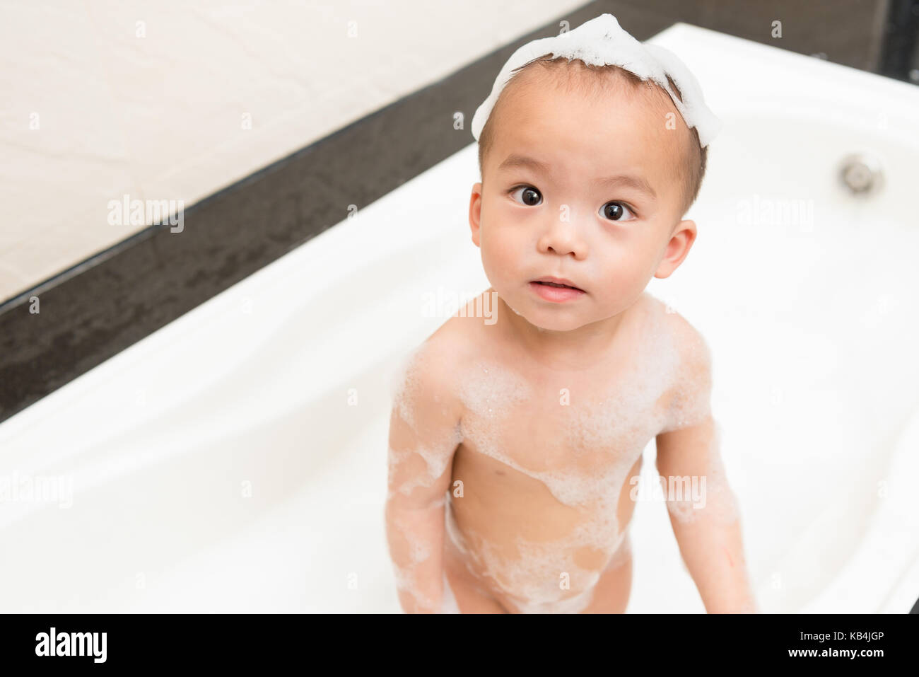 Boy standing in tub hi-res stock photography and images - Alamy