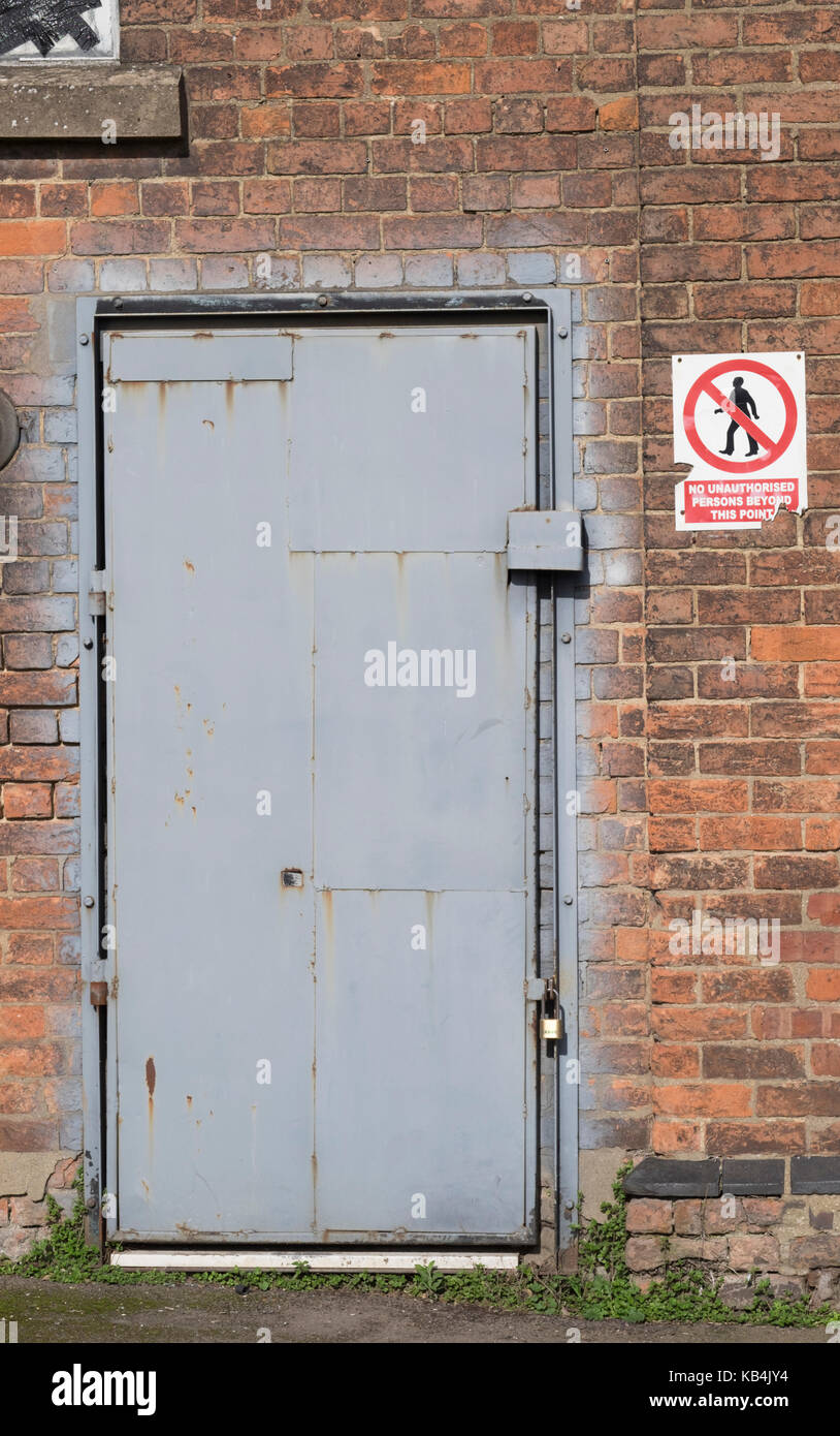 Steel door with hazard warning sign Stock Photo - Alamy
