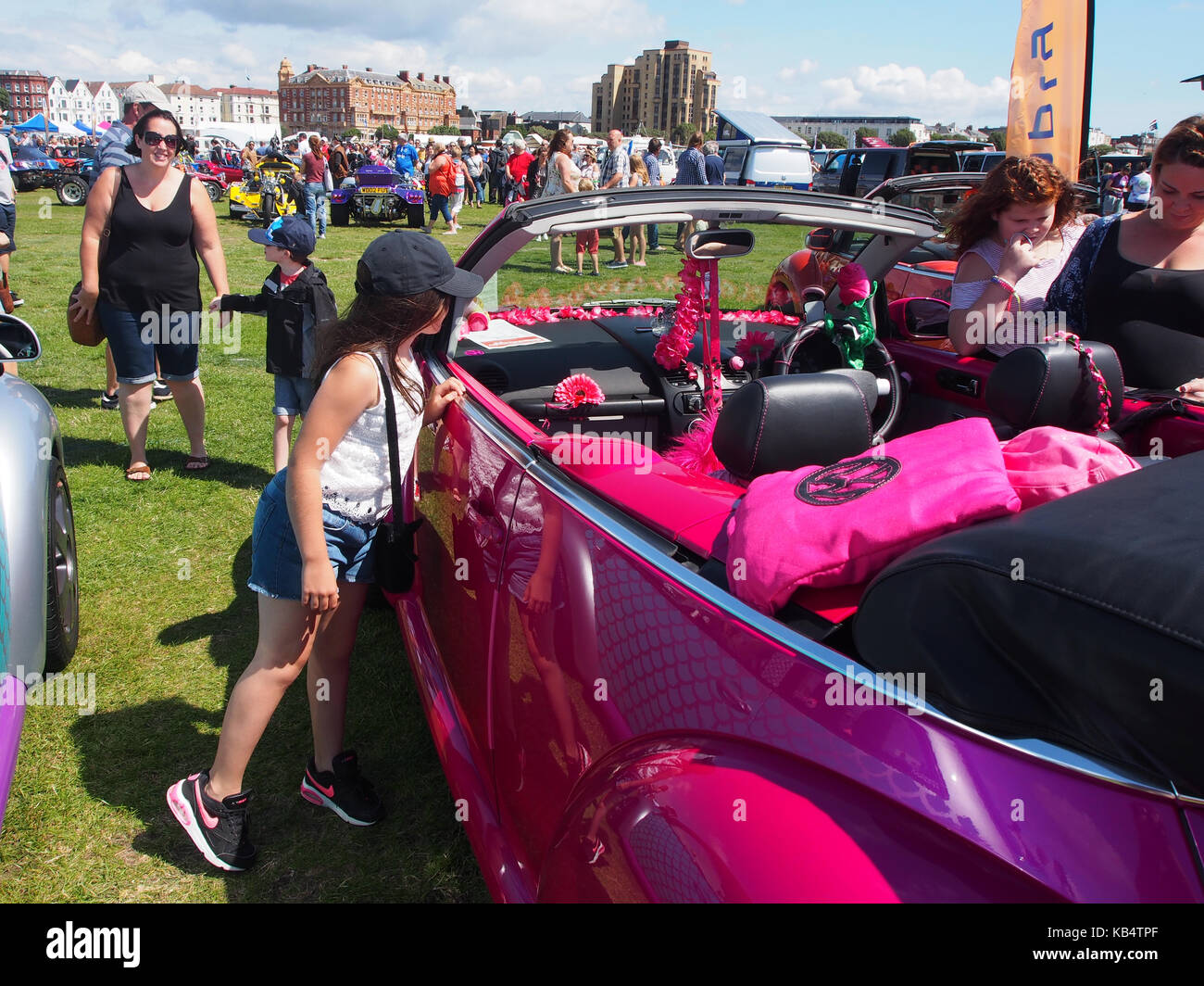 A young girl looks at a pink customised Volkswagen Beetle Stock Photo ...