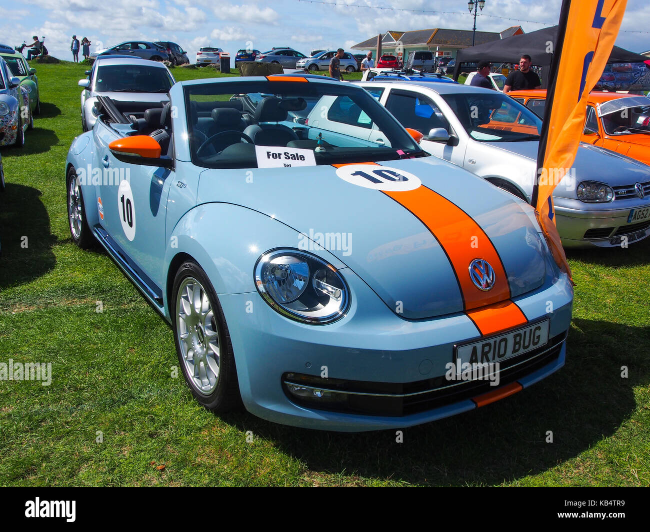 A row of VW beetles with their boots open displaying their engines ...
