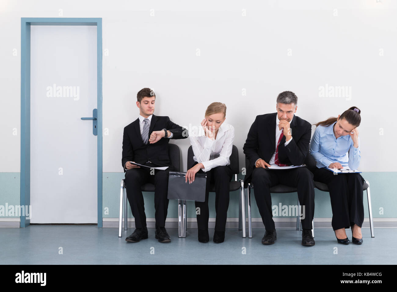 Businesspeople Sitting On Chair Waiting For Job Interview In Office ...