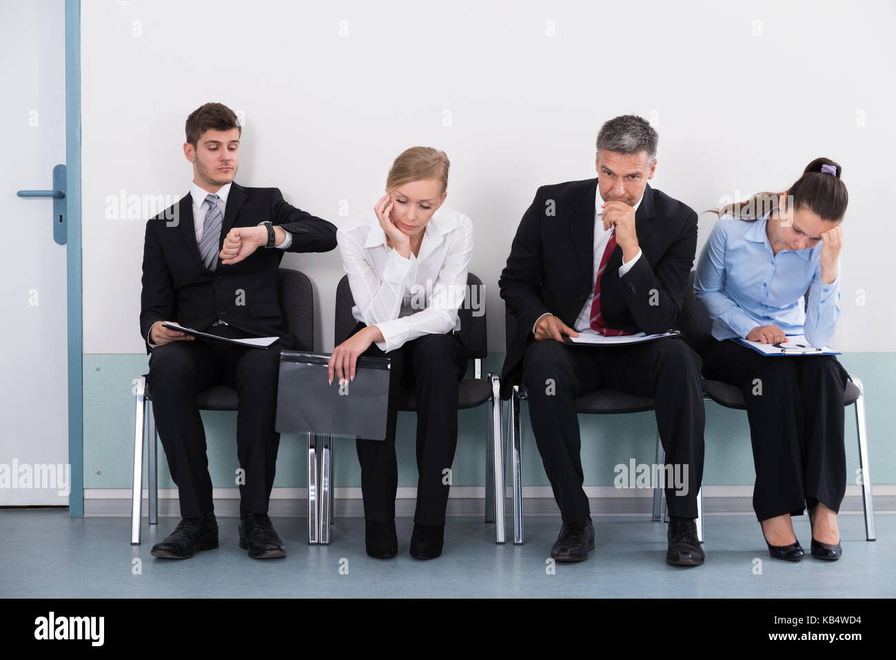 Businesspeople Sitting On Chair Waiting For Job Interview In Office ...