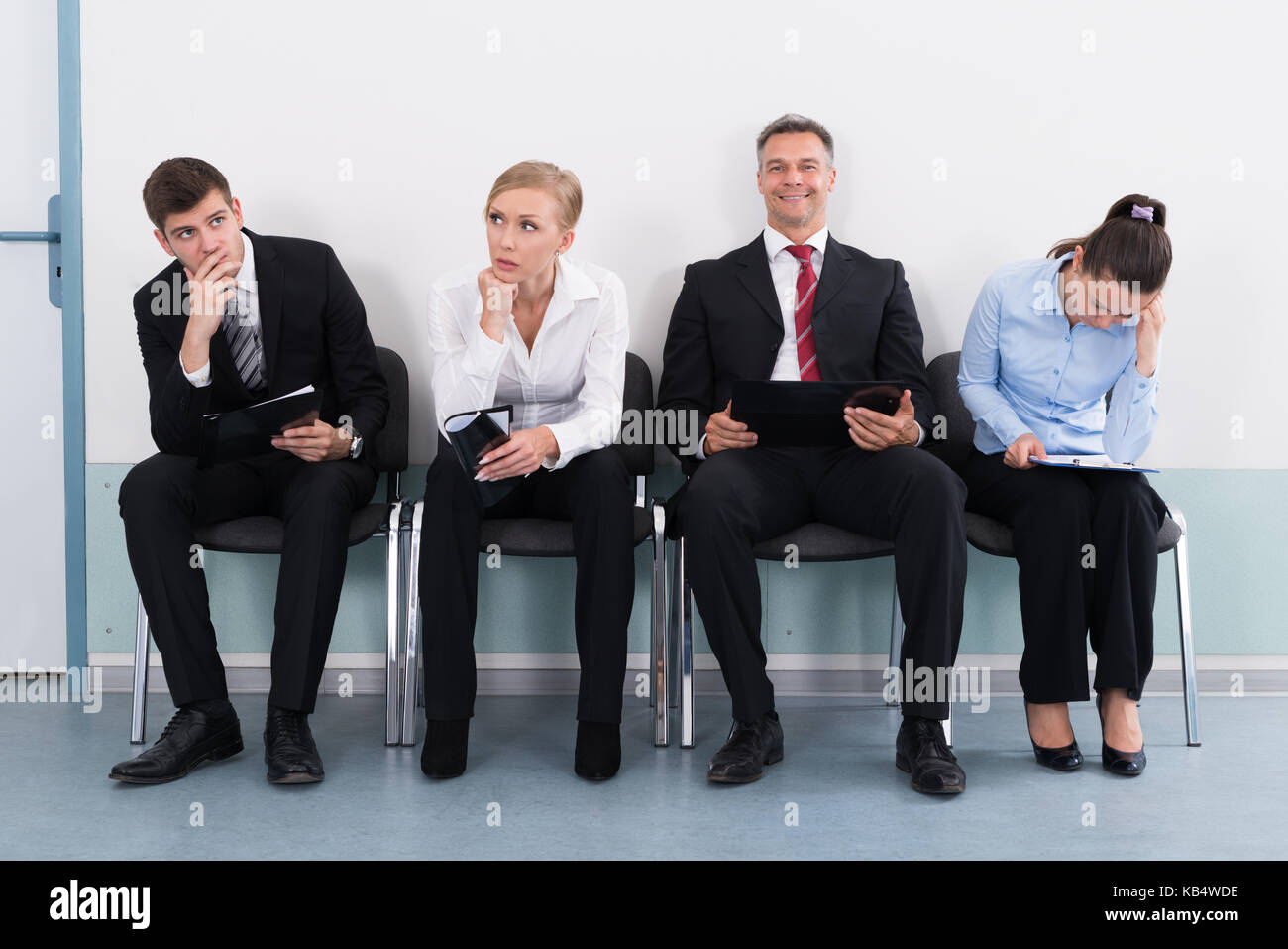 Businesspeople Sitting On Chair Waiting For Job Interview In Office ...