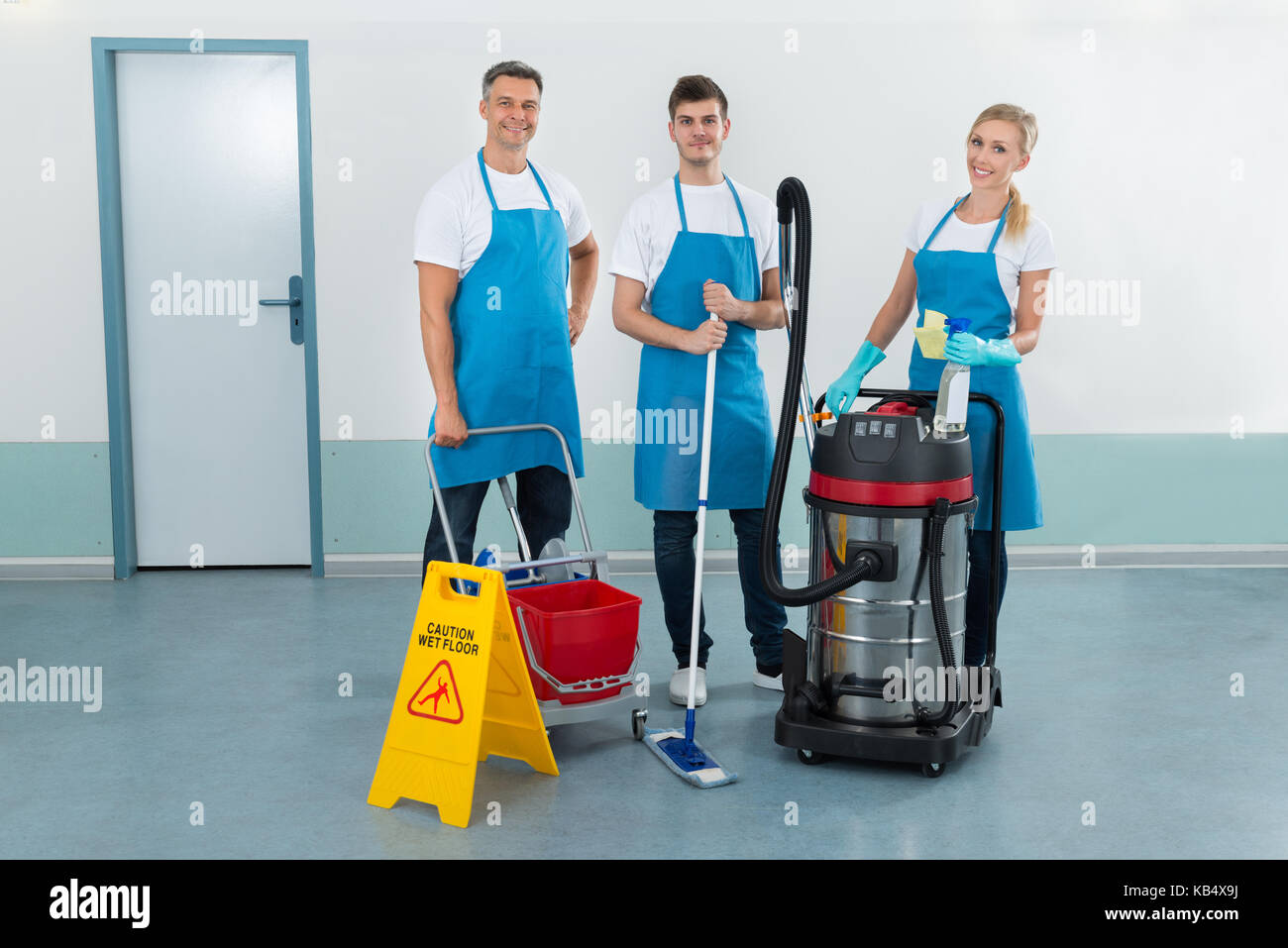 Portrait Of Happy Three Workers With Cleaning Equipments Stock Photo ...