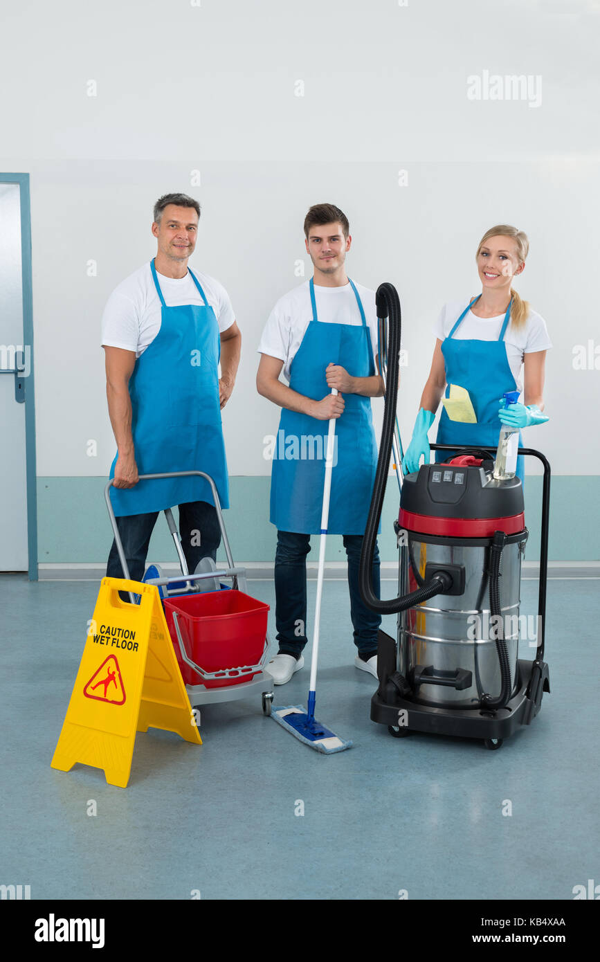 Portrait Of Happy Three Workers With Cleaning Equipments Stock Photo ...