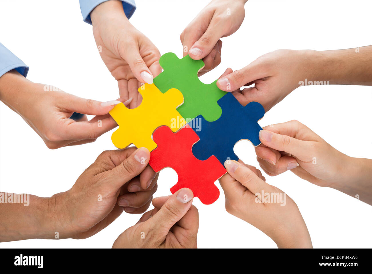Close-up Of People Hands Connecting Together Jigsaw Pieces Stock Photo ...