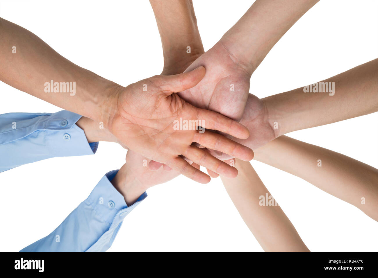 Low Angle View Of People Hands Stacking Together Over White Background ...