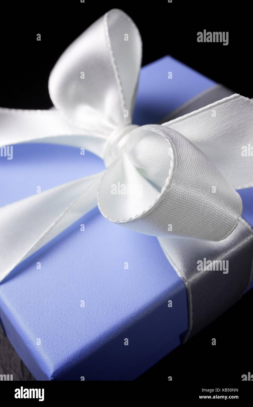 Luxury box tied with a white ribbon Stock Photo - Alamy