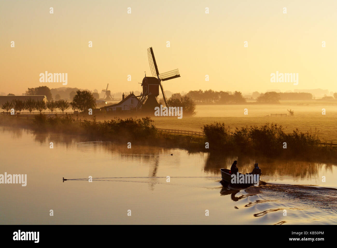 Windmill and boat at sunrise, Hoogmade, South Holland, The Netherlands ...