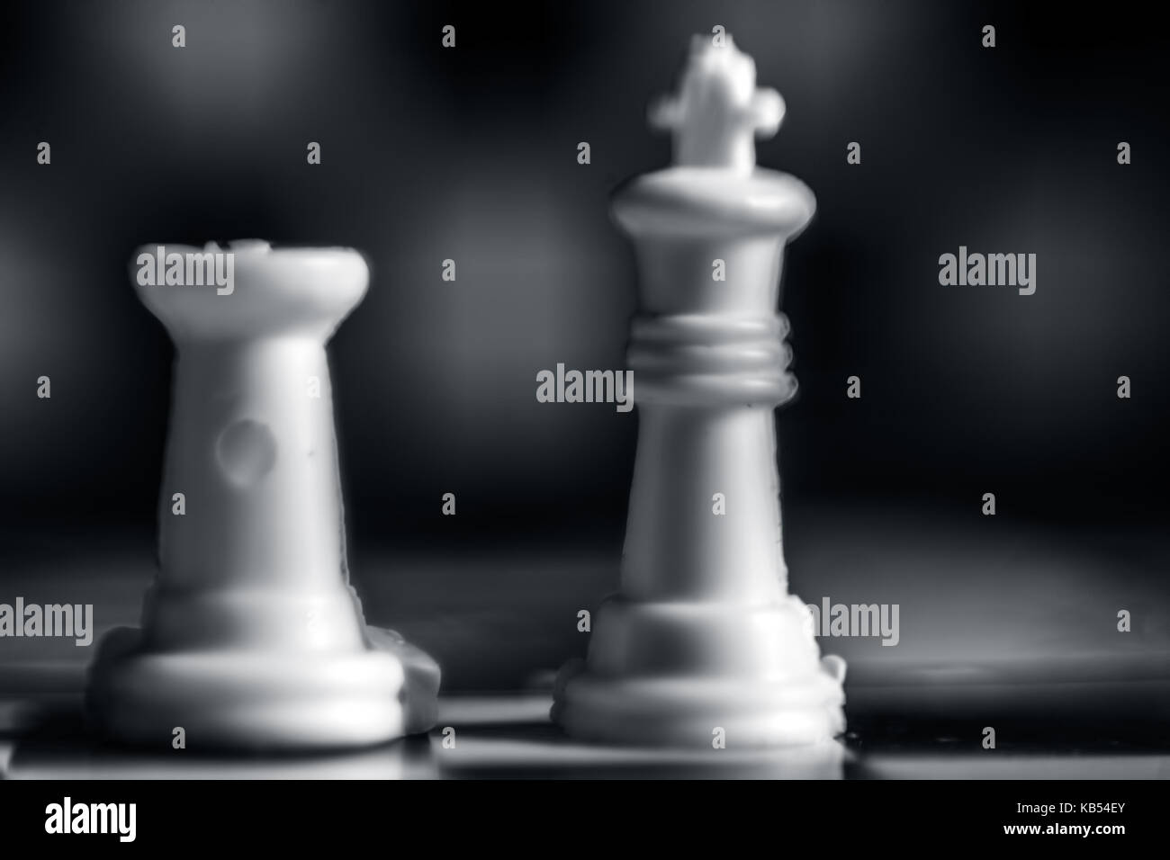 Rook and Queen soldier on the chess board Stock Photo - Alamy