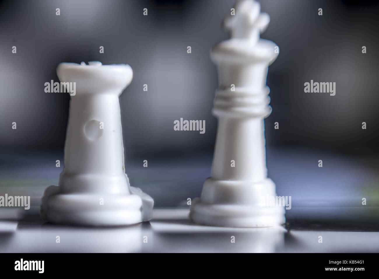 Rook and queen standing on chess board Stock Photo - Alamy