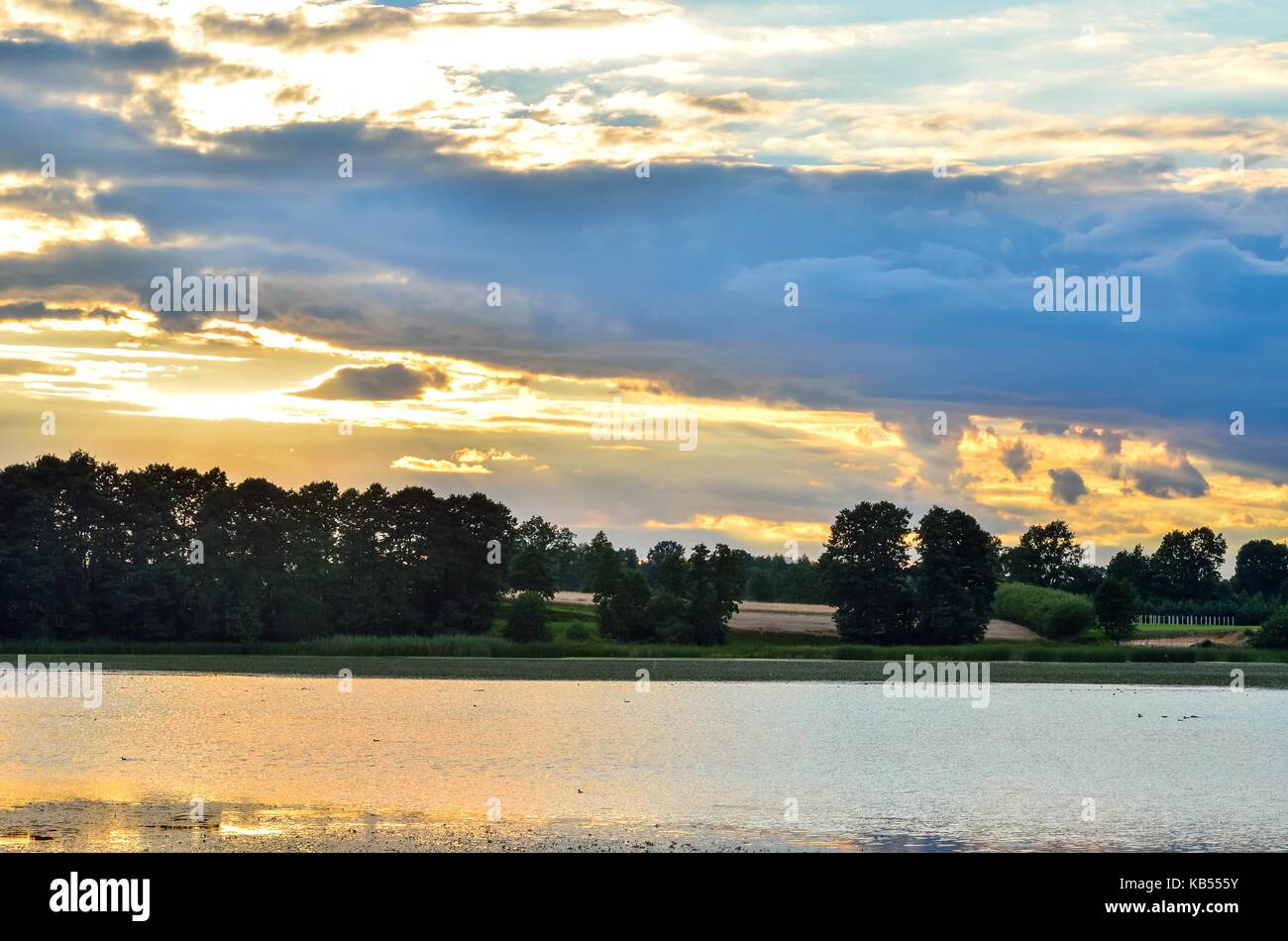 Summer evening landscape. Sunset over the water Stock Photo - Alamy