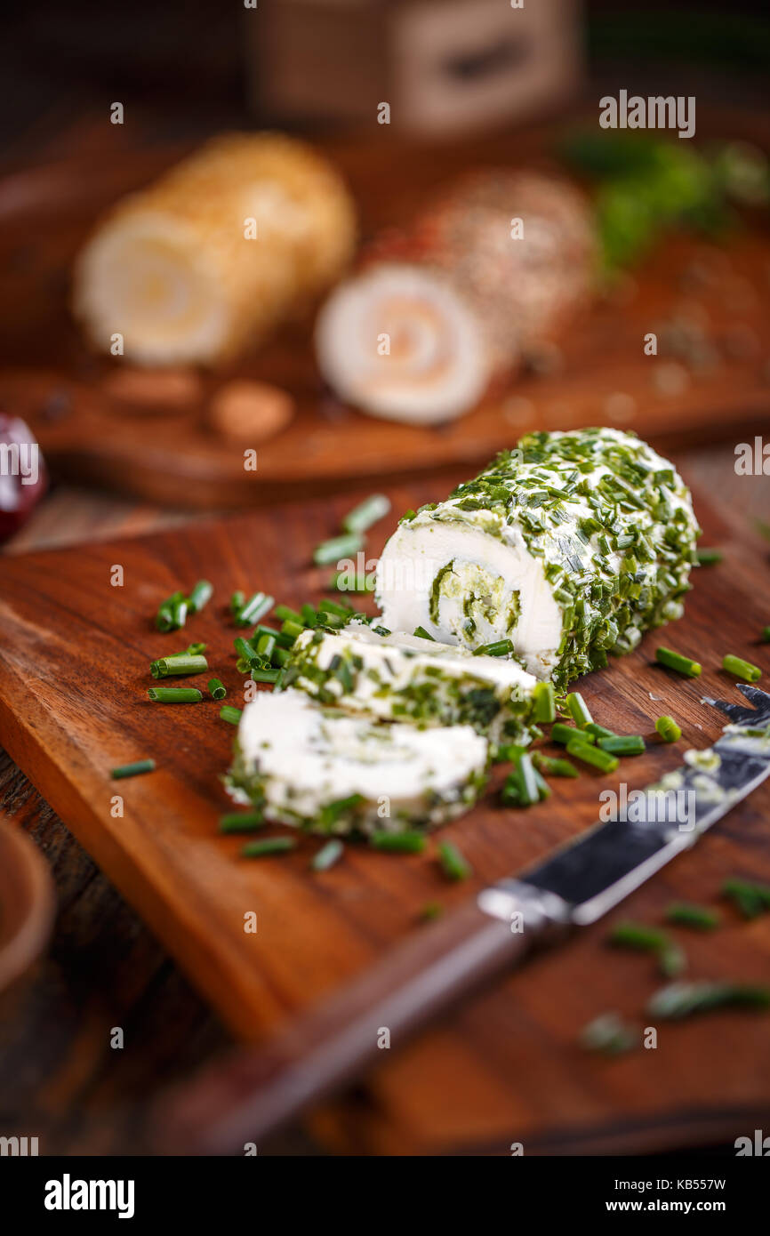 Delicious soft cheese with fresh herbs served on a cutting board Stock ...