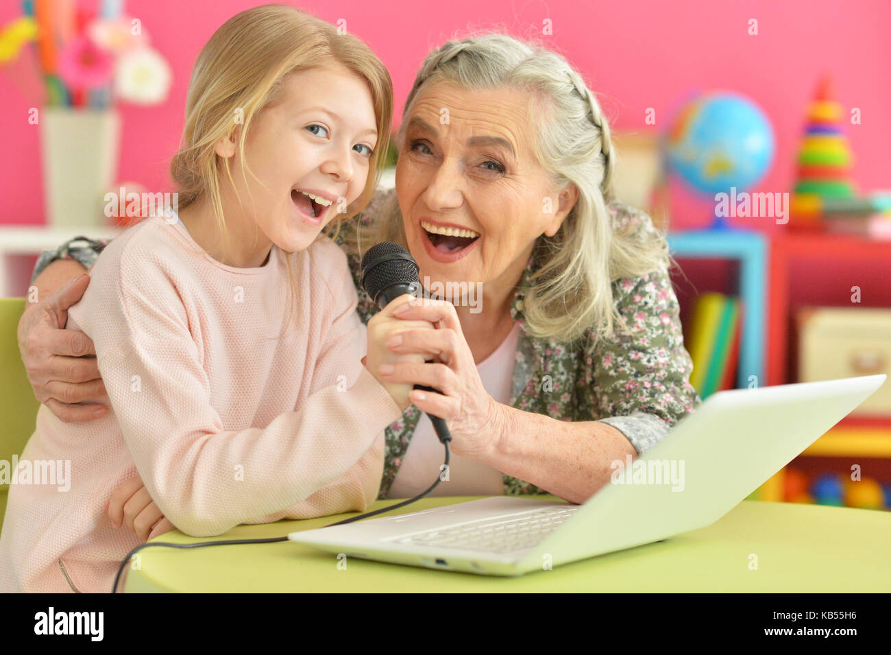 girl with grandmother singing karaoke Stock Photo - Alamy