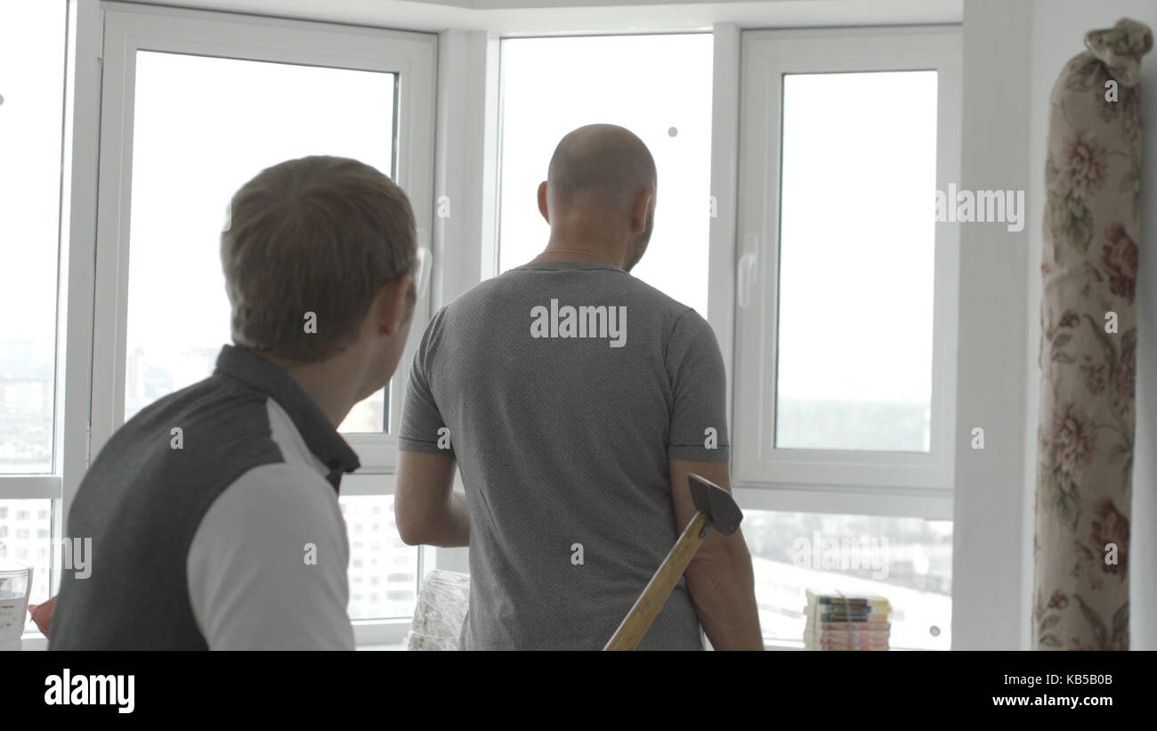 Man sneaks up behind to hit with a hammer. Swings a hammer to hit Stock ...