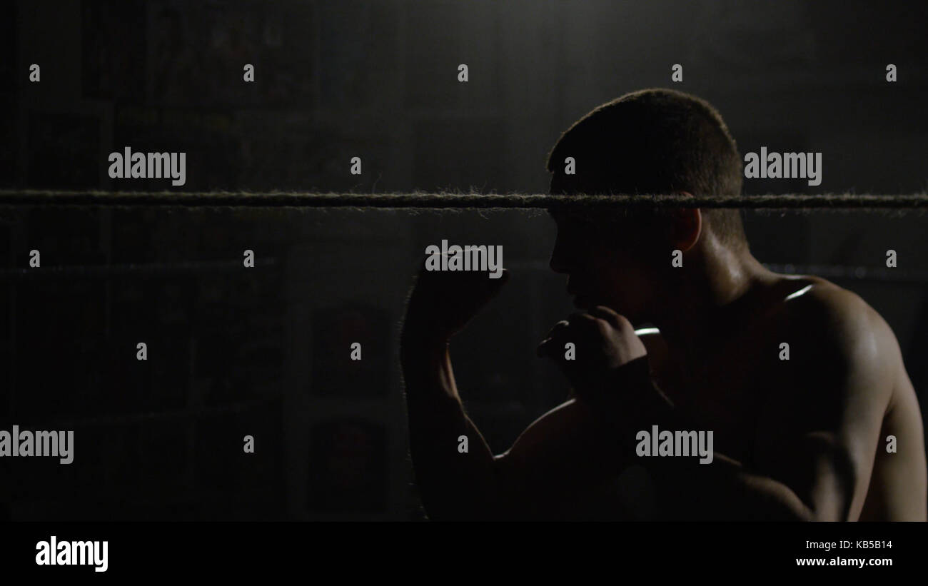Boxer man doing exercises. Boxer doing exercises with a rope for slope ...