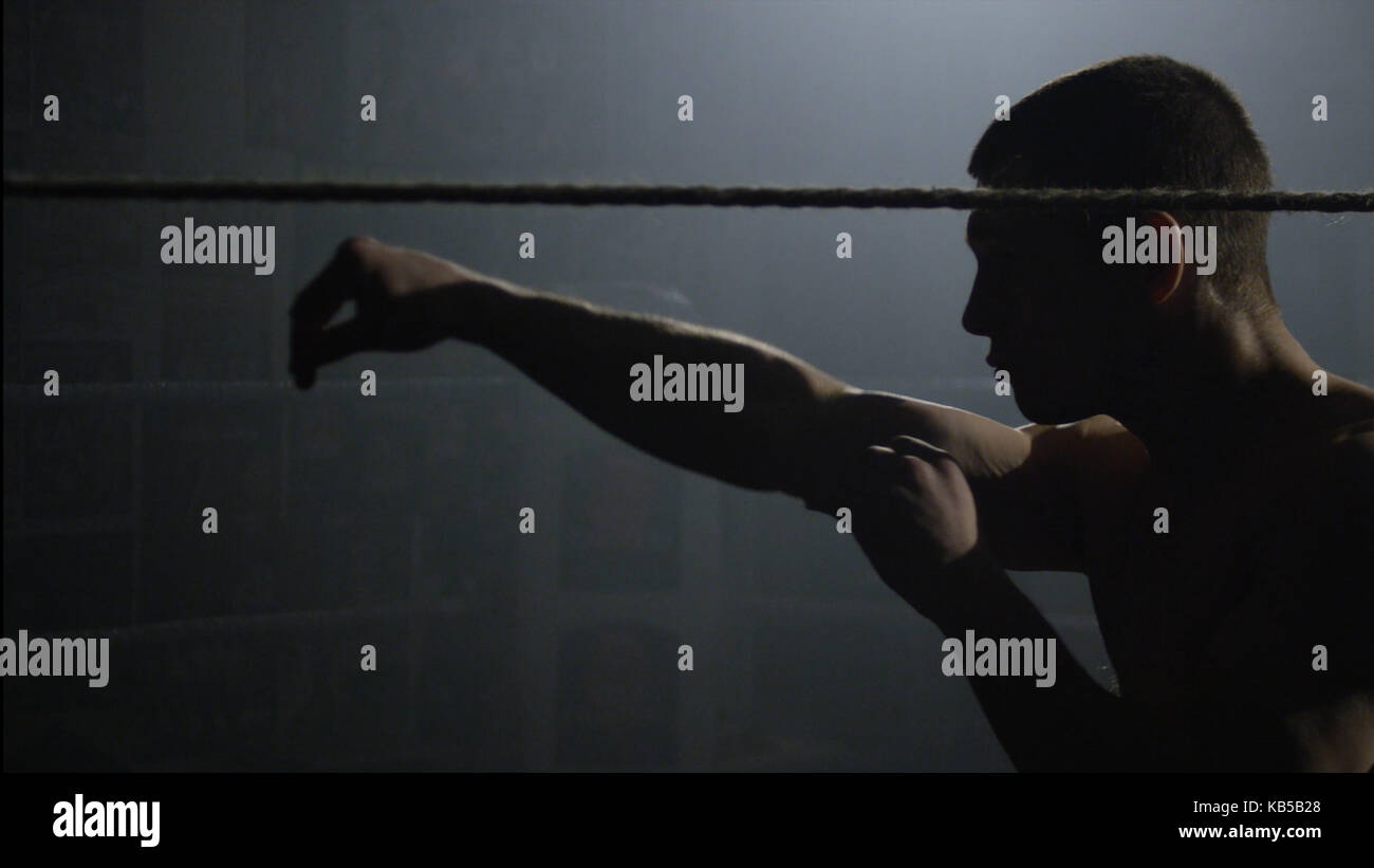 Boxer man doing exercises. Boxer doing exercises with a rope for slope ...