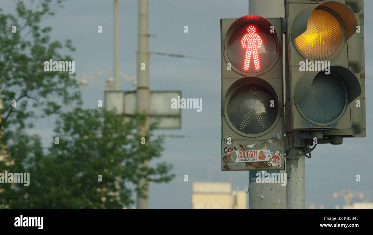 Close up urban city traffic light changing to green from red signal ...