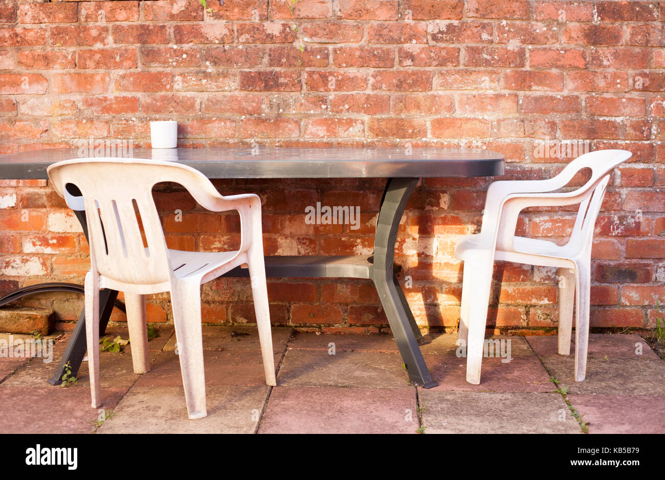 White modern chair on brick wall Stock Photo - Alamy
