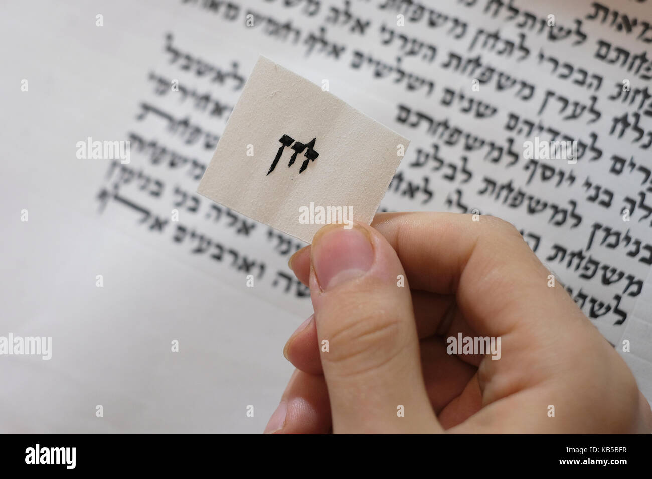A religious Jewish "Stam" calligrapher holds the name Chen in Hebrew ...