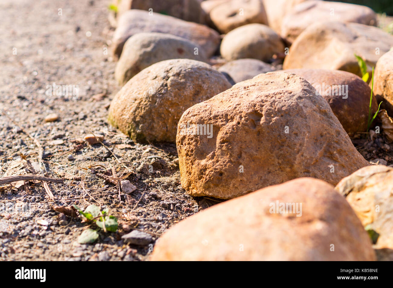 border of stones near the walkway. nature, peace Stock Photo - Alamy