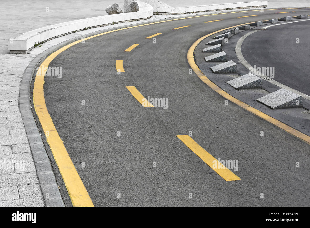Street Bend with Yellow Marking Lines Stock Photo - Alamy