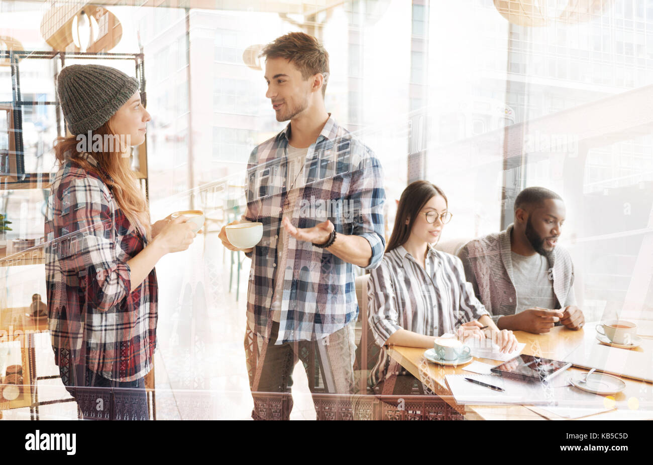 Excited friends having interesting talk Stock Photo - Alamy