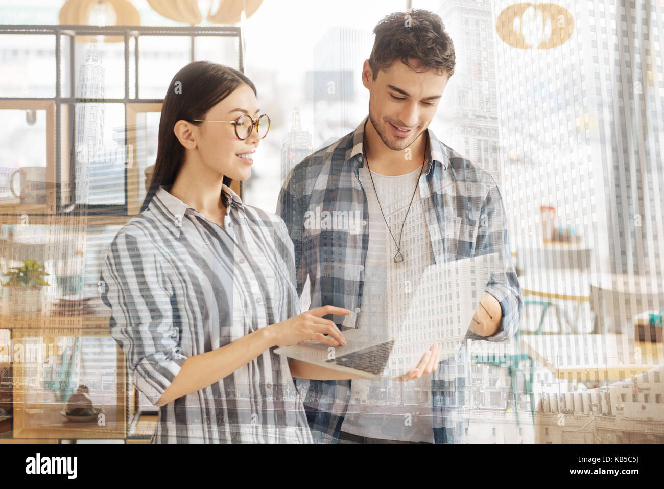 Positive couple using a laptop Stock Photo - Alamy