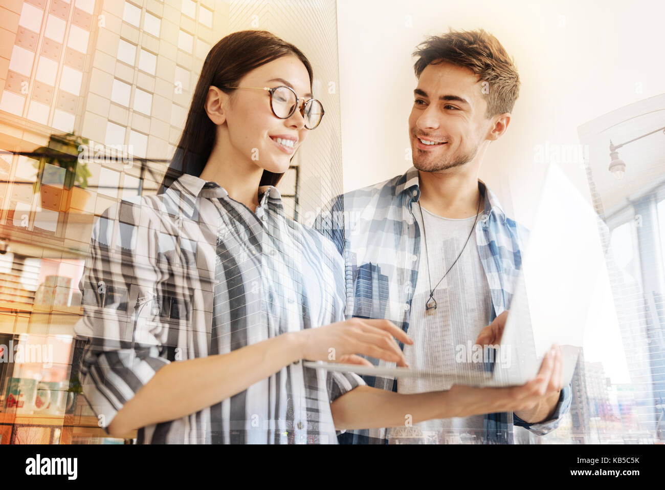 Adorable couple looking at the screen Stock Photo - Alamy