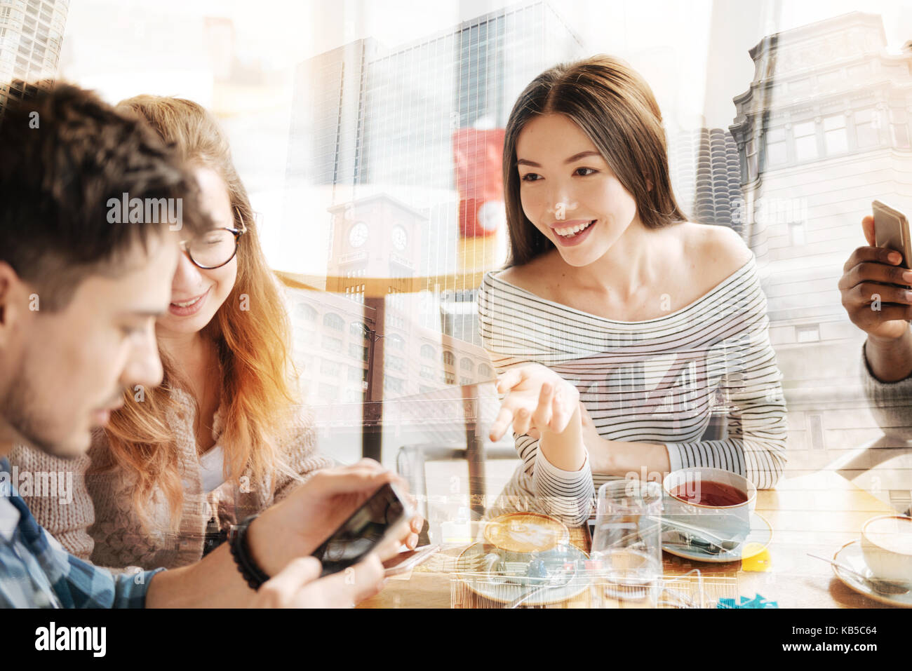Relaxed friends drinking tea together Stock Photo - Alamy
