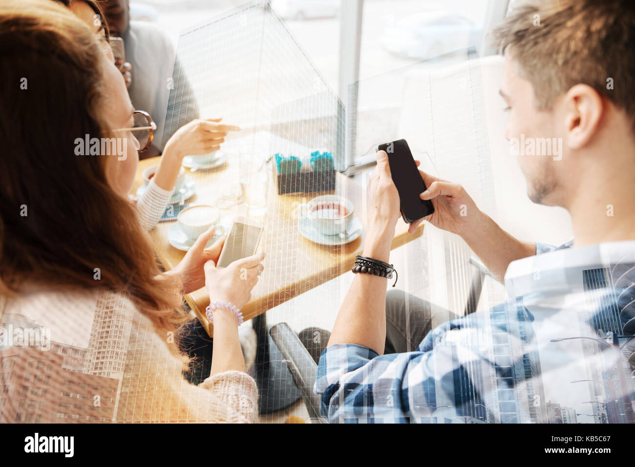 Attentive friends using mobile phones Stock Photo - Alamy