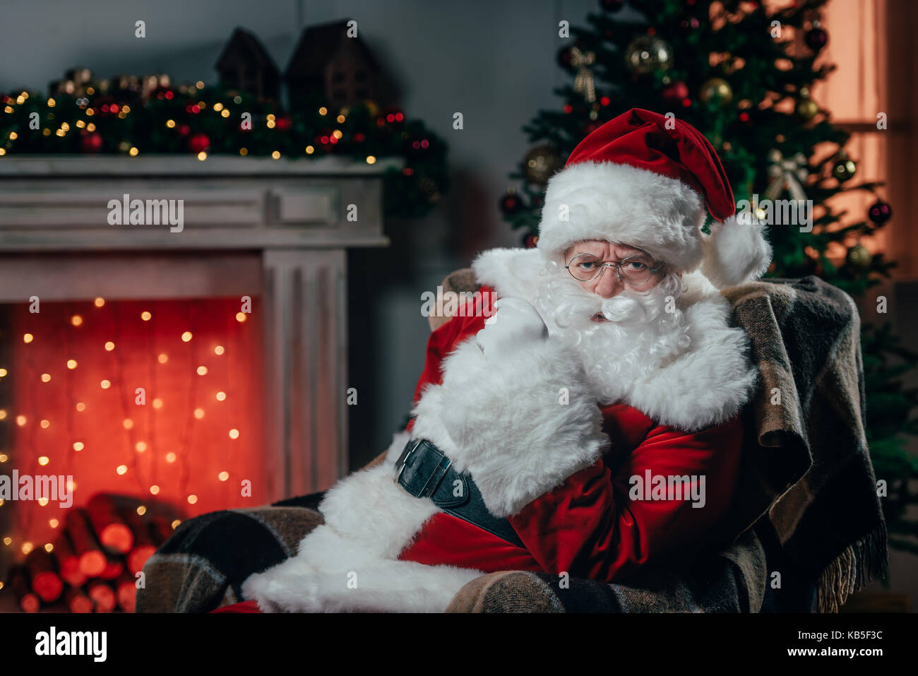 santa claus sitting in armchair Stock Photo - Alamy