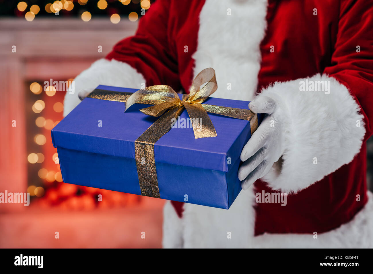 santa holding gift box Stock Photo - Alamy