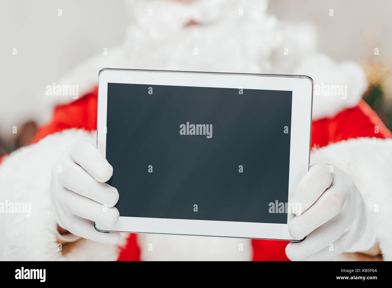 santa claus presenting tablet Stock Photo - Alamy