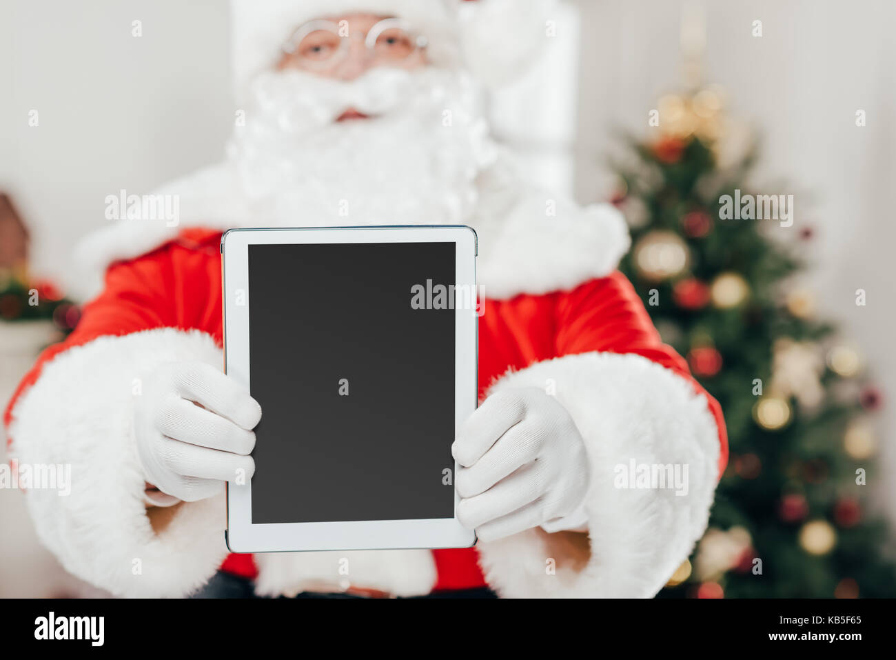 santa claus presenting tablet Stock Photo - Alamy