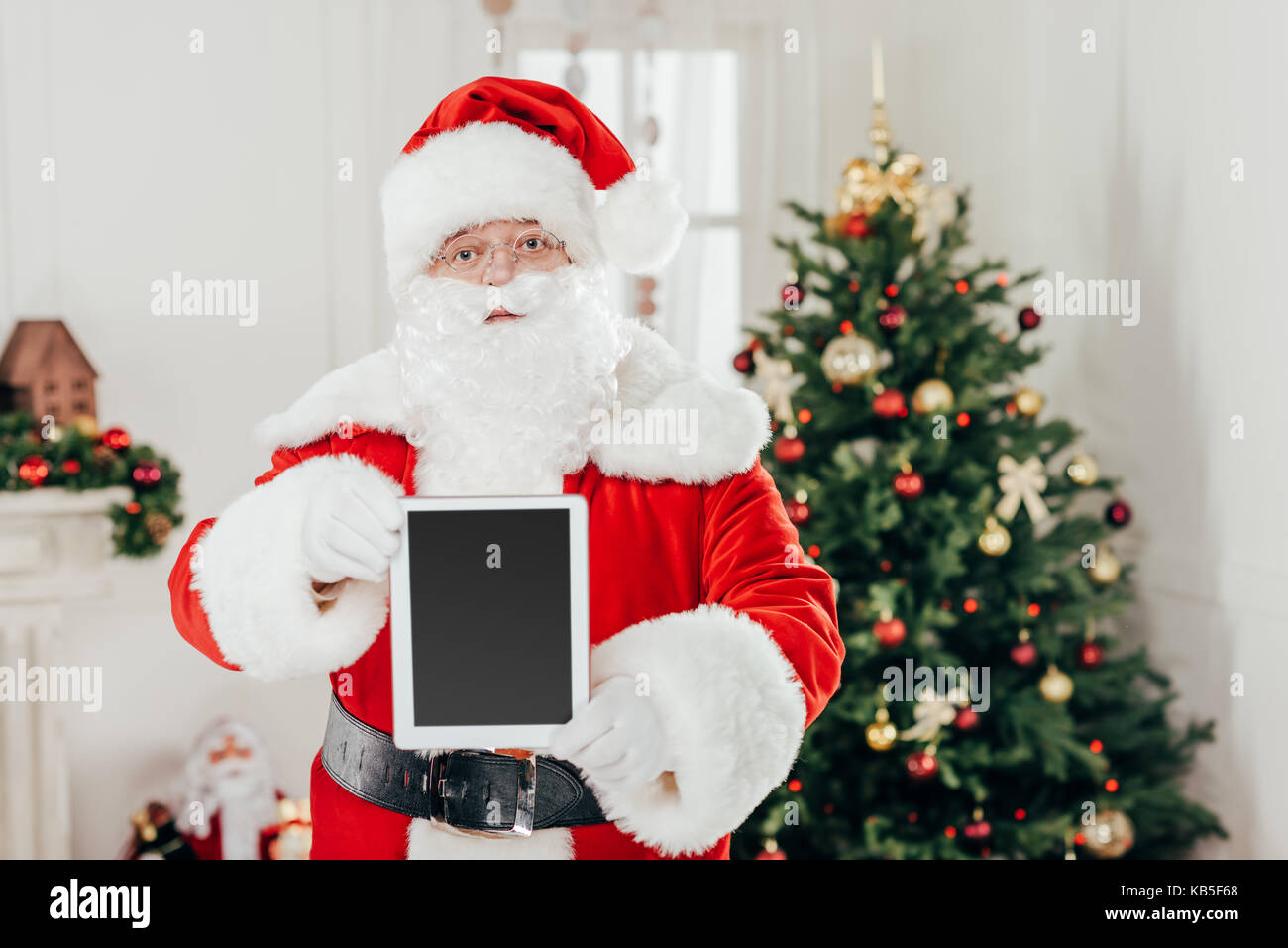 santa claus presenting tablet Stock Photo - Alamy
