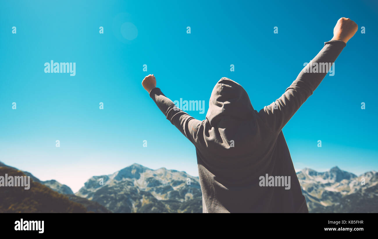 Winning and success. Victorious female person standing on mountain top ...