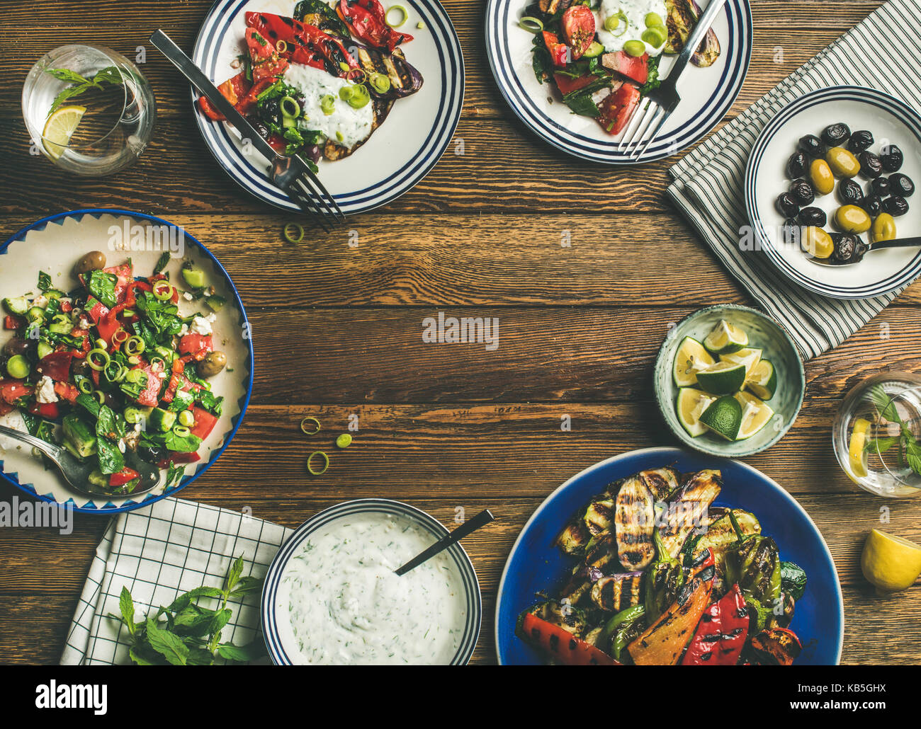 Flat-lay of healthy dinner table setting with vegetarian appetizers ...
