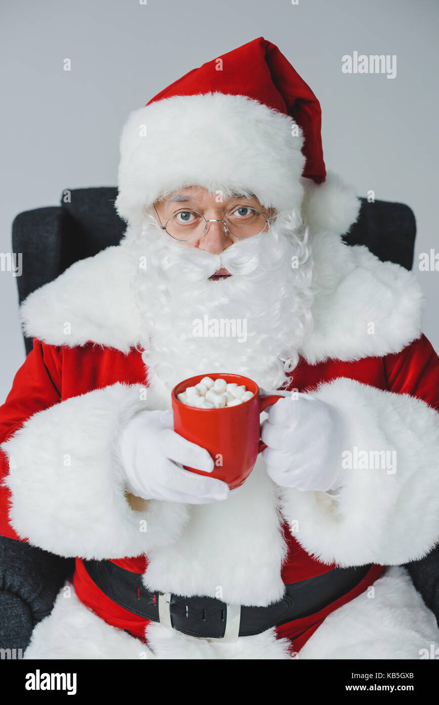 santa drinking hot chocolate with marshmallows Stock Photo - Alamy