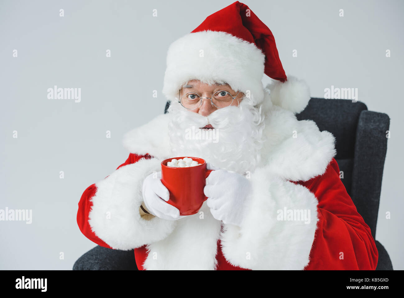 santa drinking hot chocolate with marshmallows Stock Photo - Alamy