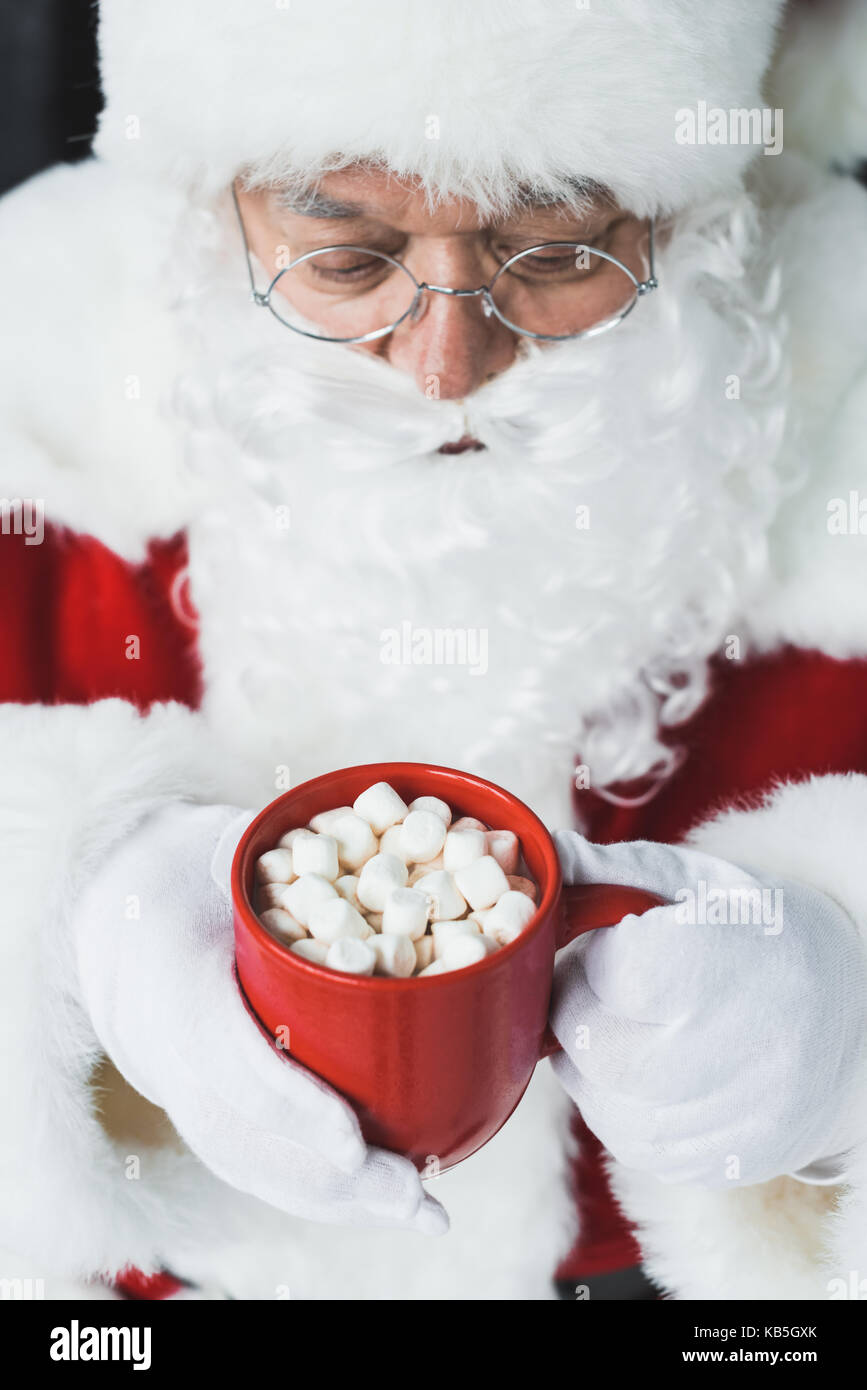 santa drinking hot chocolate with marshmallows Stock Photo - Alamy