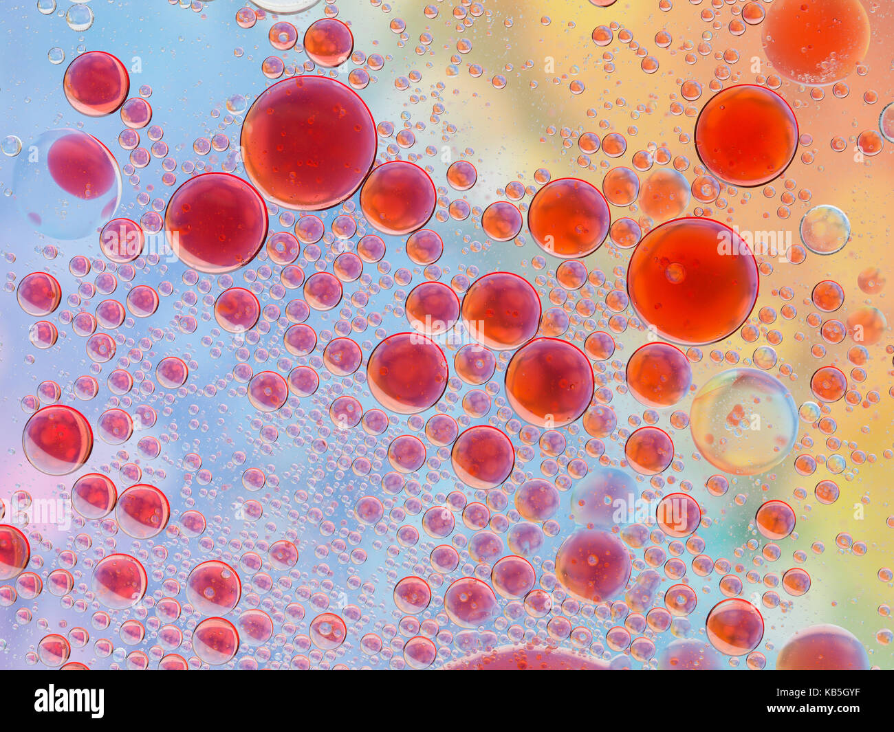 red oil bubbles on blue water Stock Photo - Alamy
