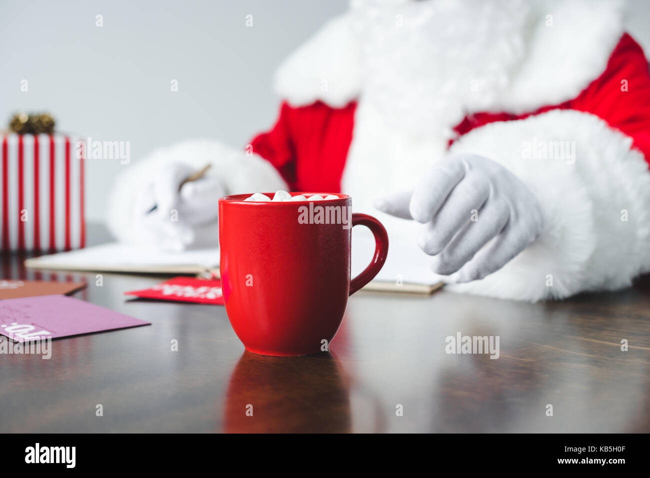 santa drinking hot chocolate with marshmallows Stock Photo - Alamy