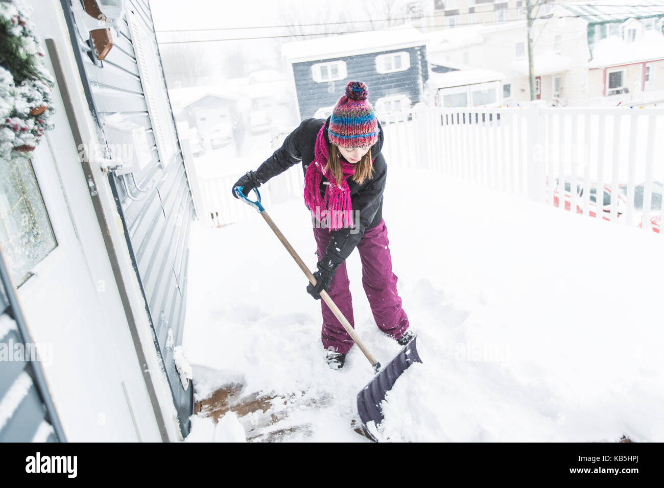woman shoveling and removing snow outside Stock Photo - Alamy