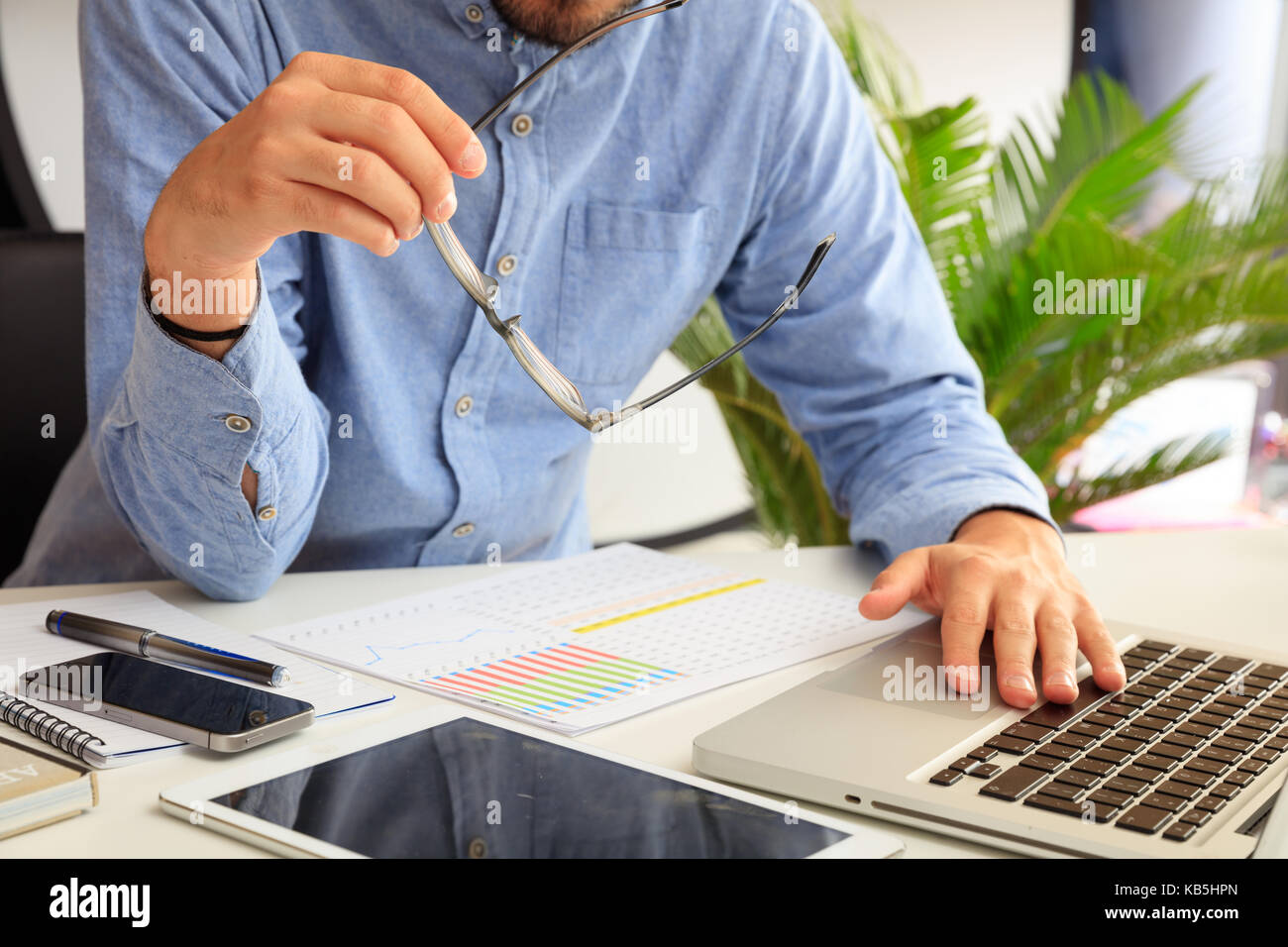 Man studying an analysis report in an office background Stock Photo - Alamy