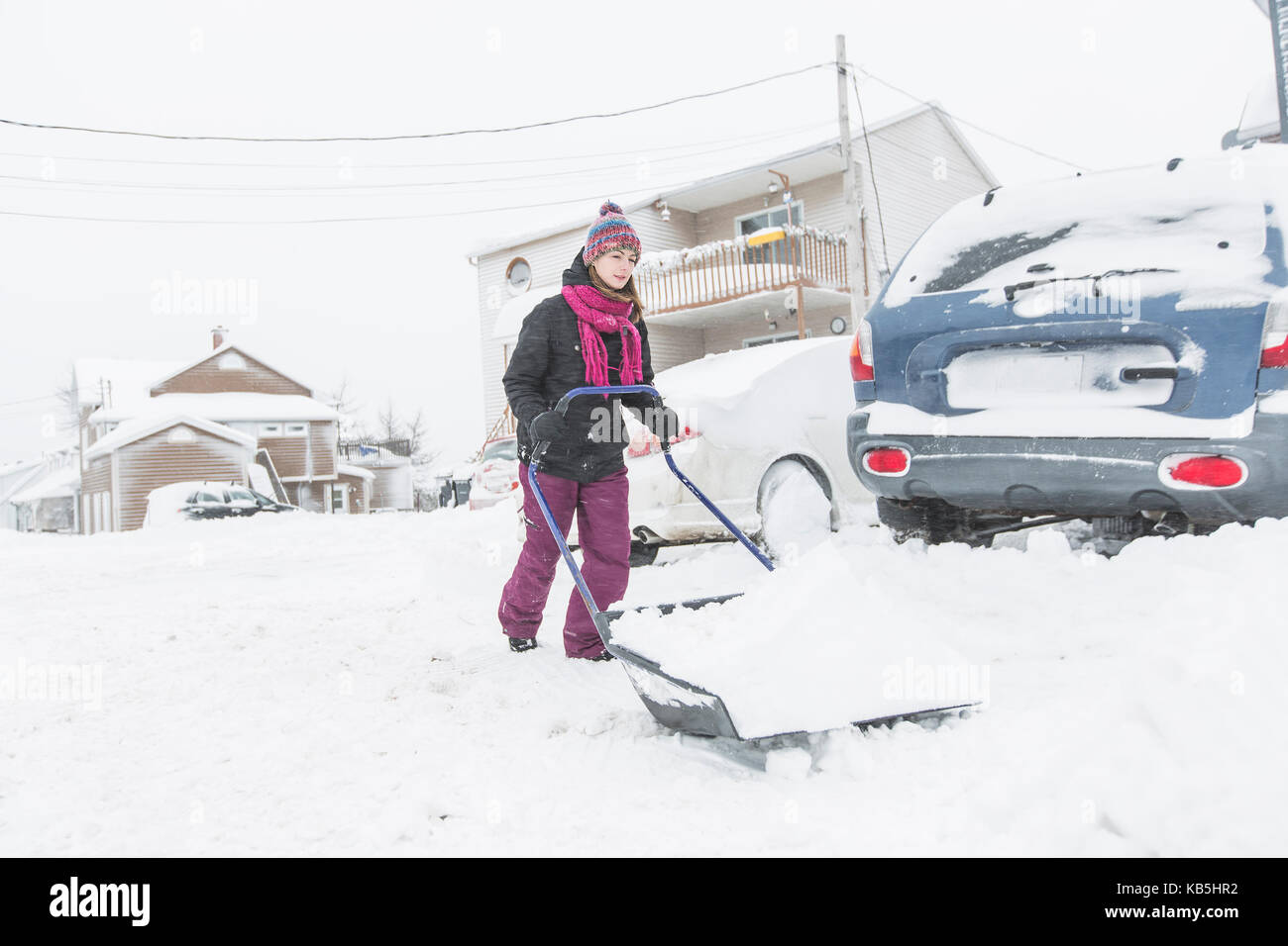 woman shoveling and removing snow outside Stock Photo - Alamy