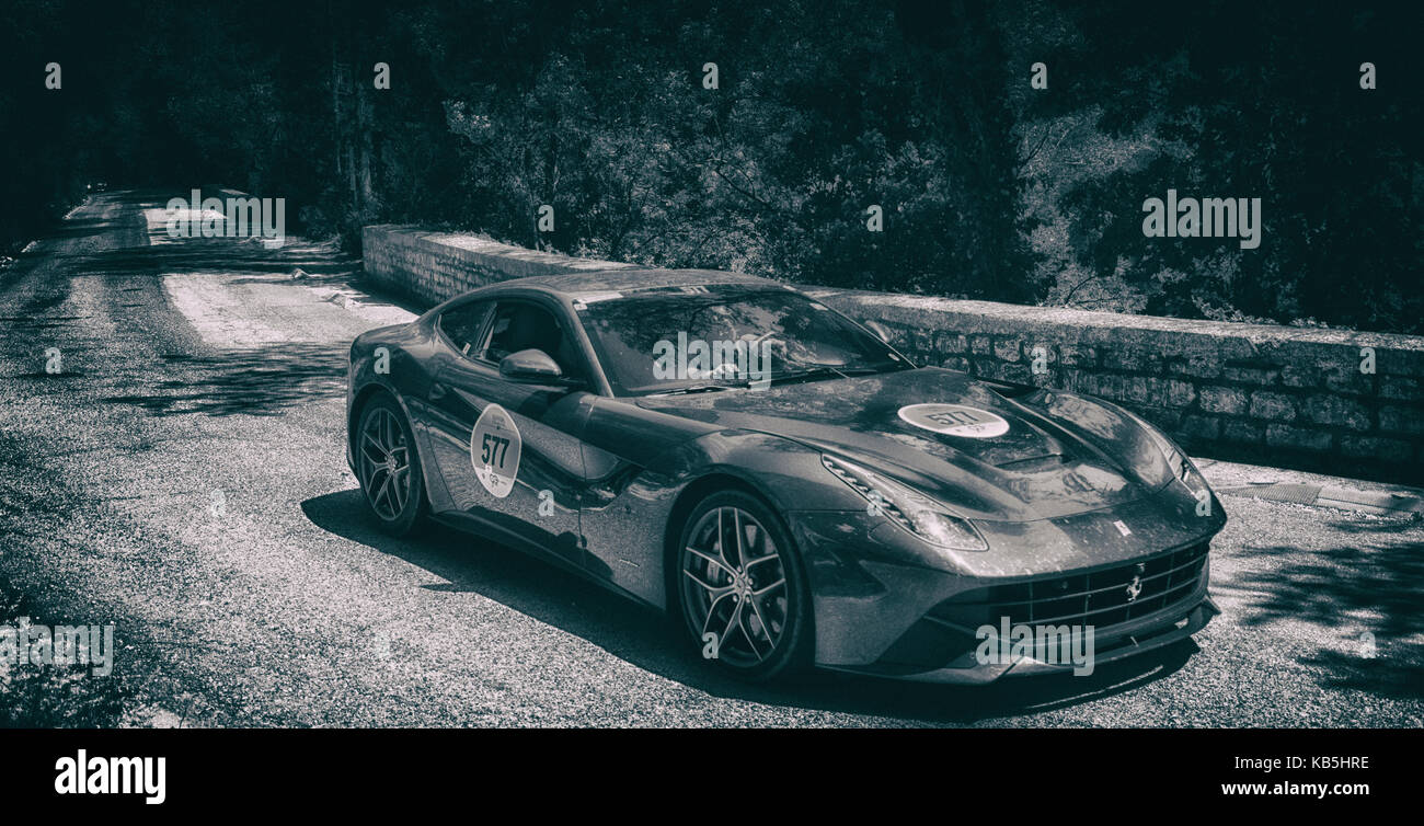 FERRARI F12 BERLINETTA 2015 on an old racing car in rally Mille Miglia ...
